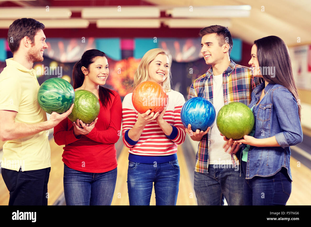 happy friends in bowling club Stock Photo - Alamy