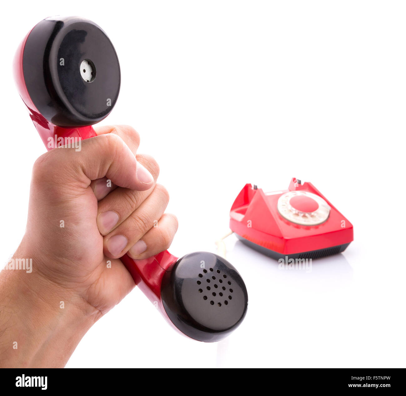Macro of handset in hand of red telephone Stock Photo - Alamy