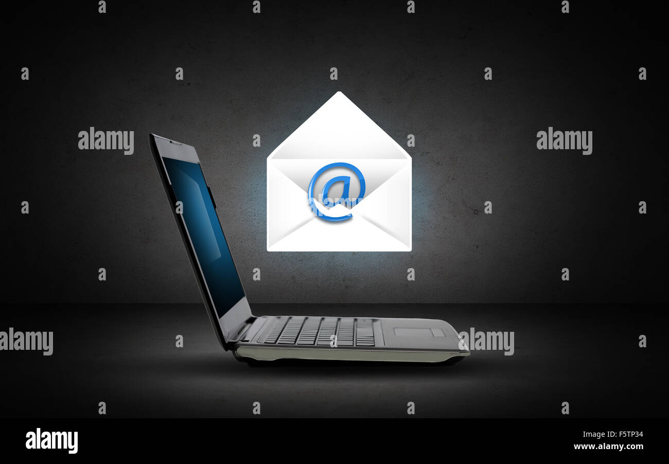 laptop computer with e-mail icon and letter Stock Photo - Alamy