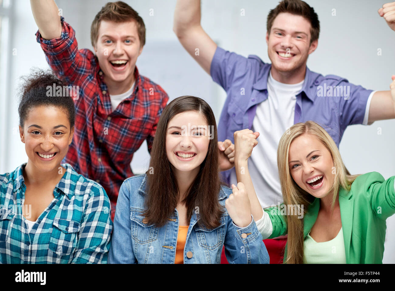 group of happy students making triumph gesture Stock Photo - Alamy
