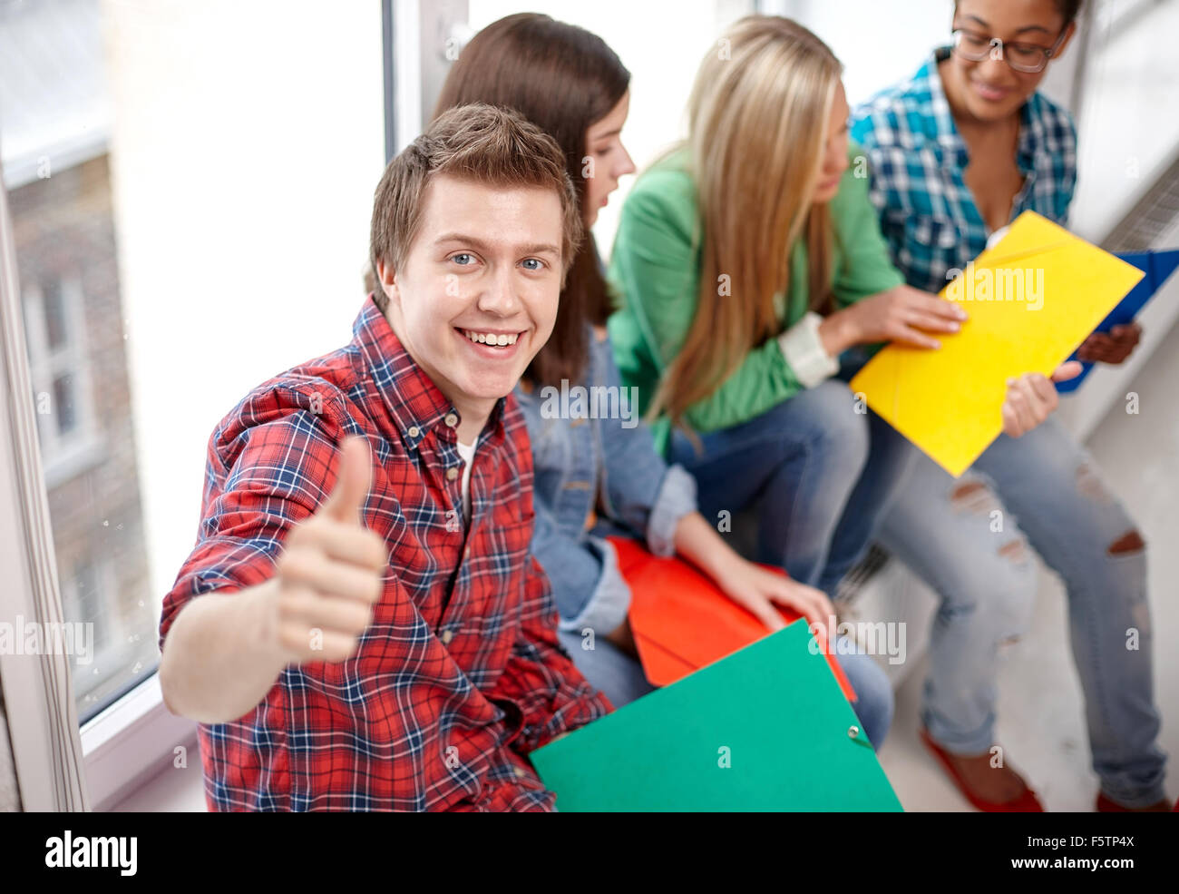 group of happy students showing thumbs up Stock Photo - Alamy