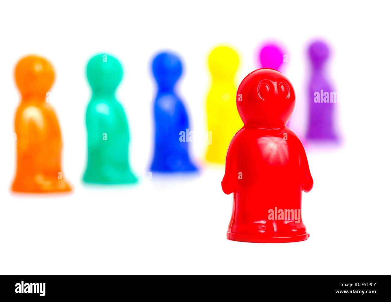 Standing out of the crowd concept. Colorful toy people group on white ...
