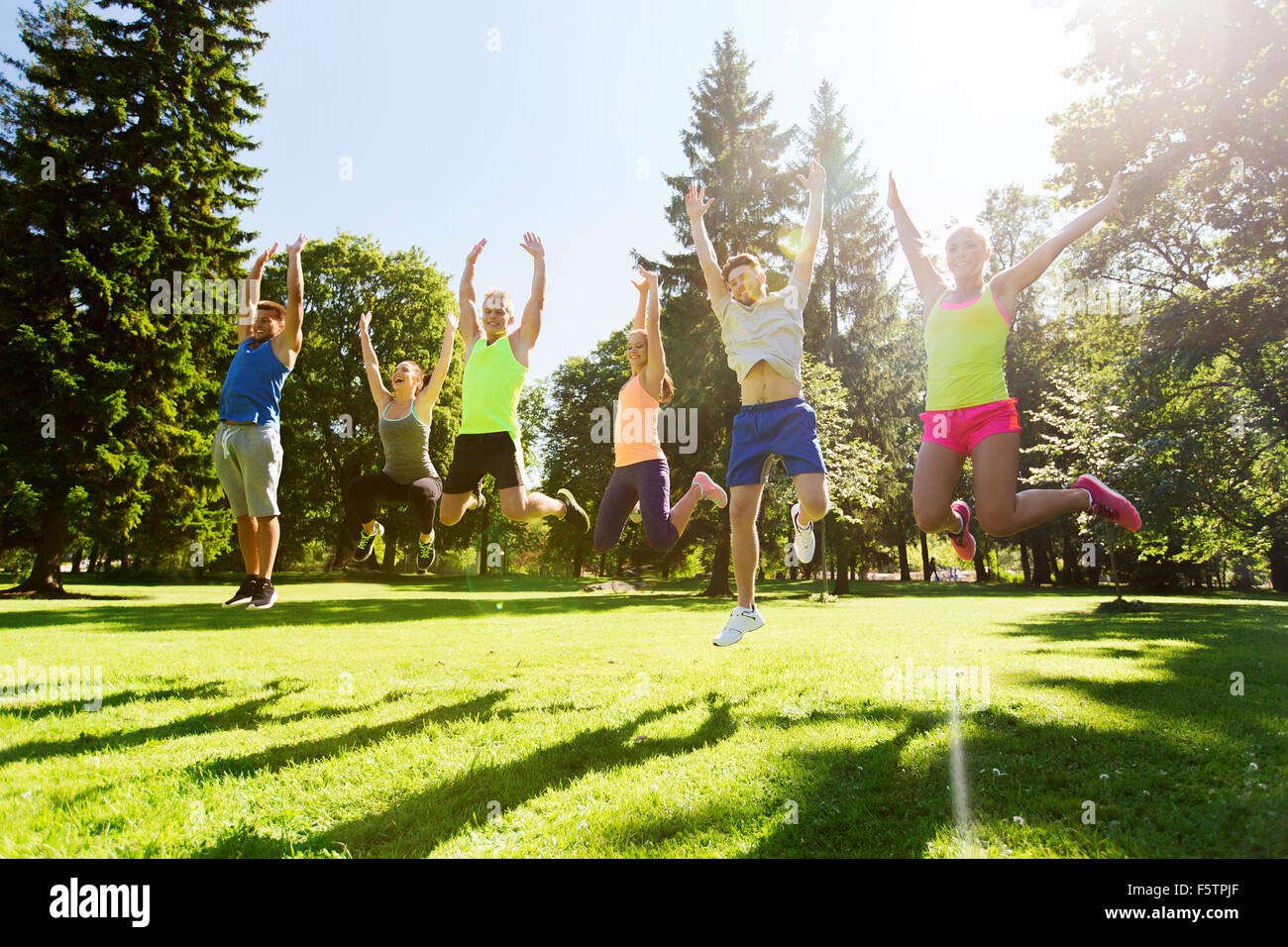 group of happy friends jumping high outdoors Stock Photo - Alamy