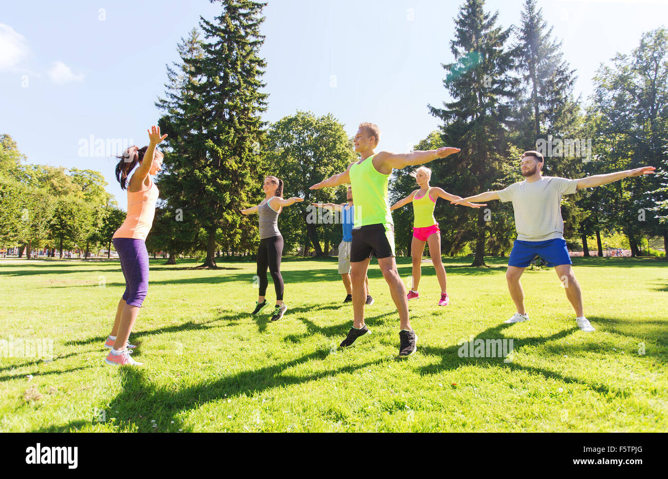 group of happy friends exercising outdoors Stock Photo - Alamy