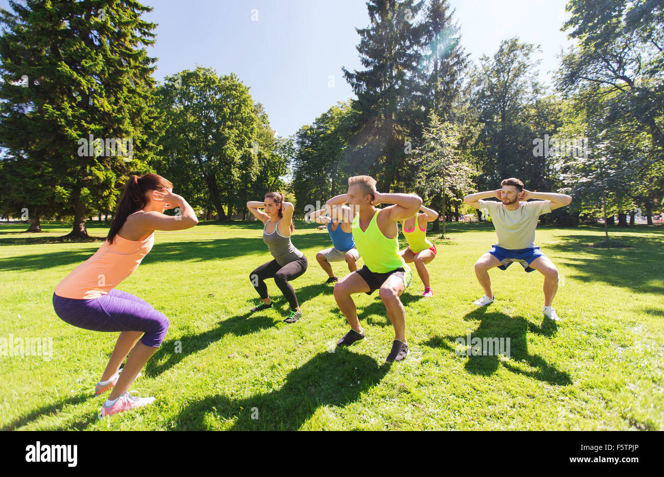 group of happy friends exercising outdoors Stock Photo - Alamy