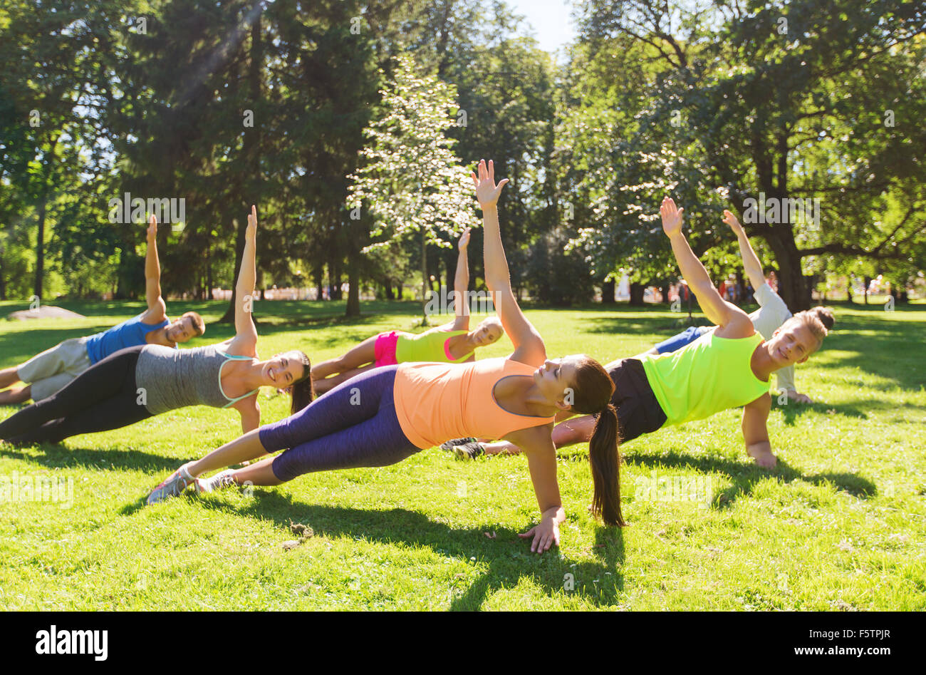 group of happy friends exercising outdoors Stock Photo - Alamy