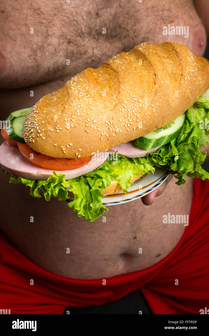 Fat happy man in glasses with sandwich Stock Photo - Alamy