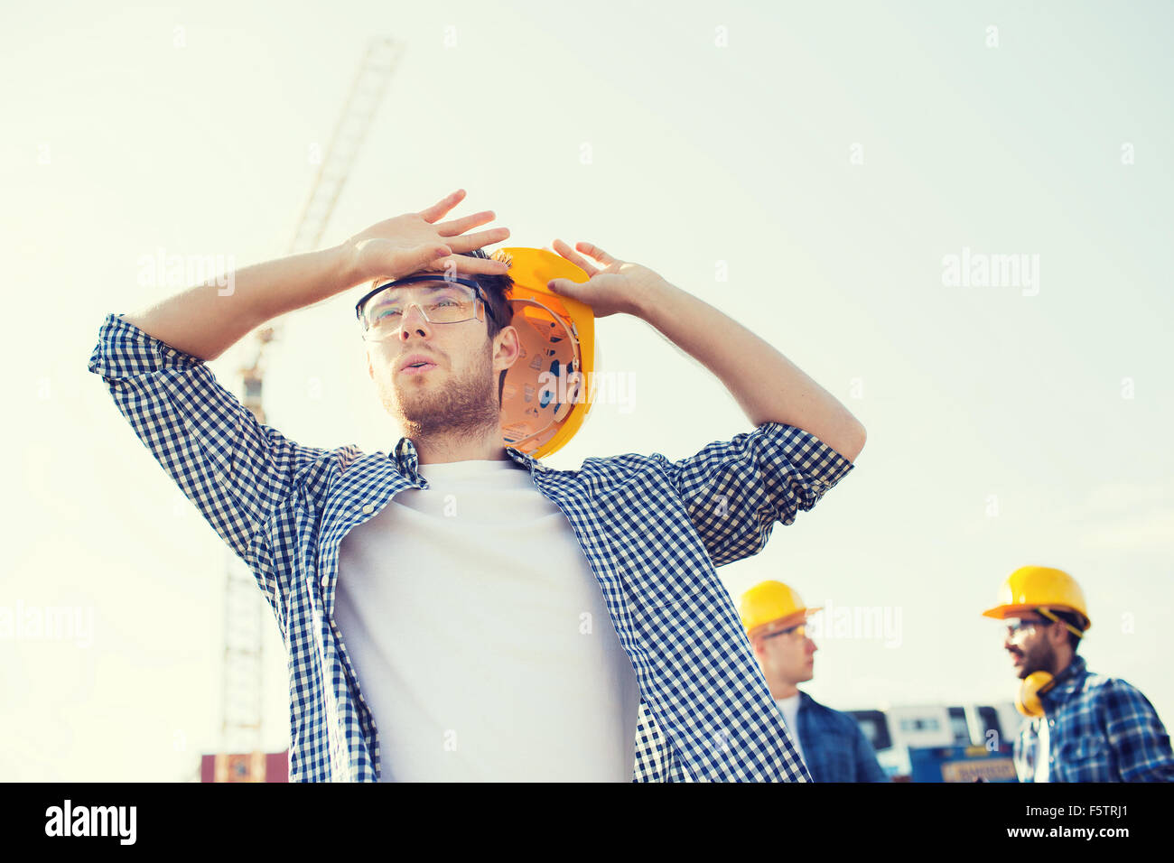 group of builders in hardhats outdoors Stock Photo - Alamy