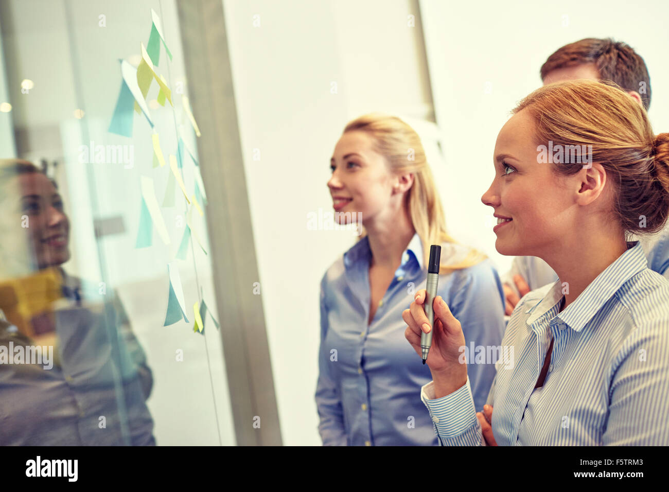smiling business people with marker and stickers Stock Photo - Alamy