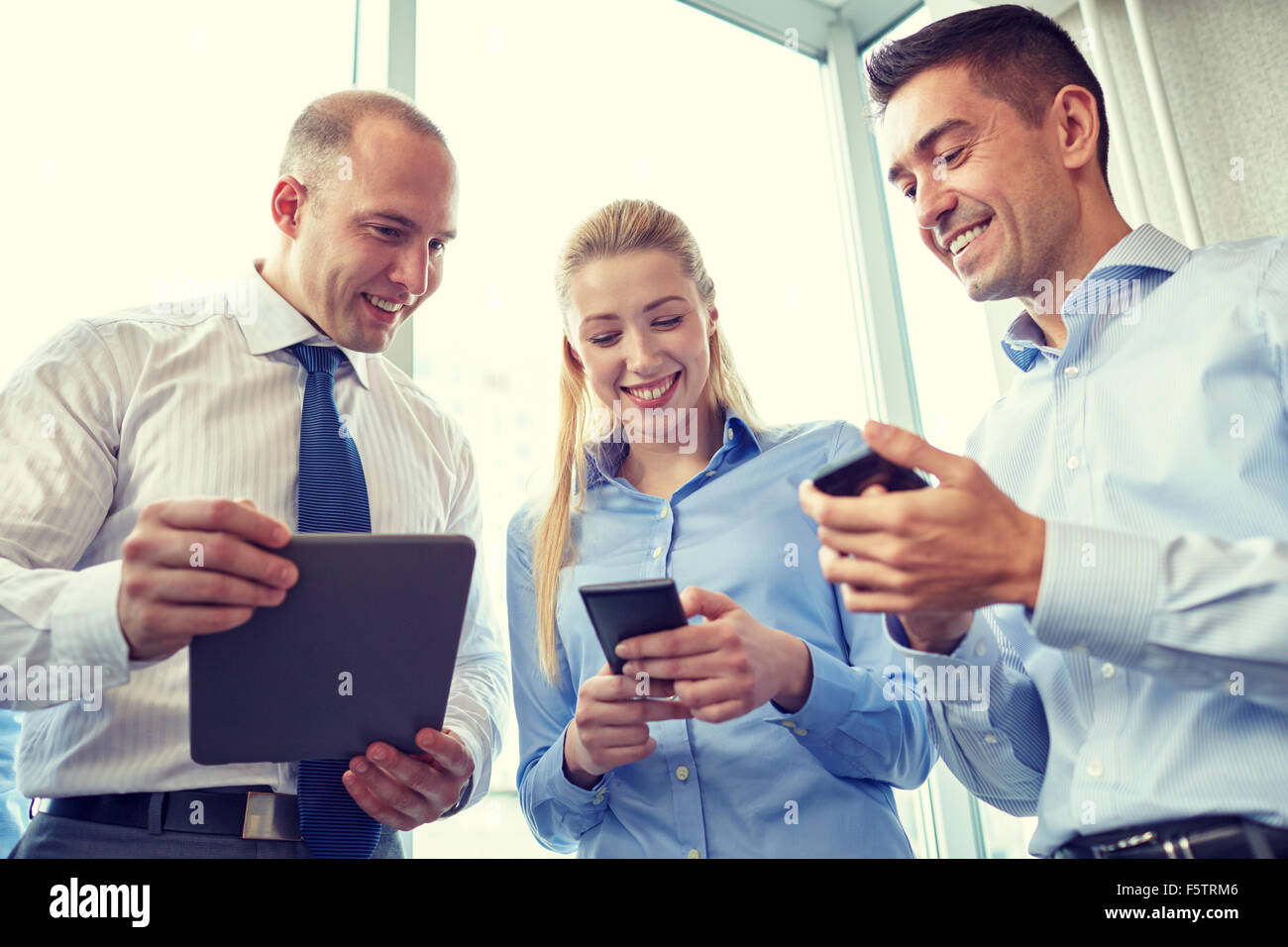 business people with tablet pc and smartphones Stock Photo - Alamy