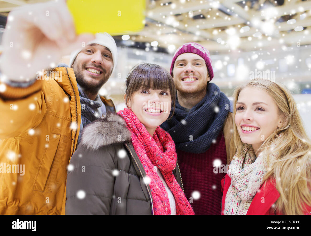 happy friends with smartphone on skating rink Stock Photo - Alamy
