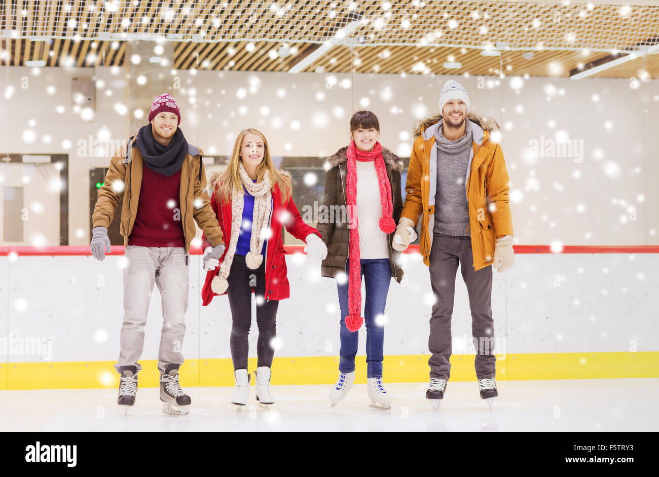 happy friends on skating rink Stock Photo - Alamy