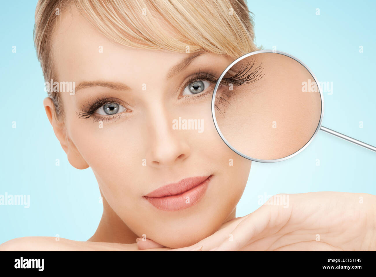 beautiful young woman face over blue background Stock Photo - Alamy