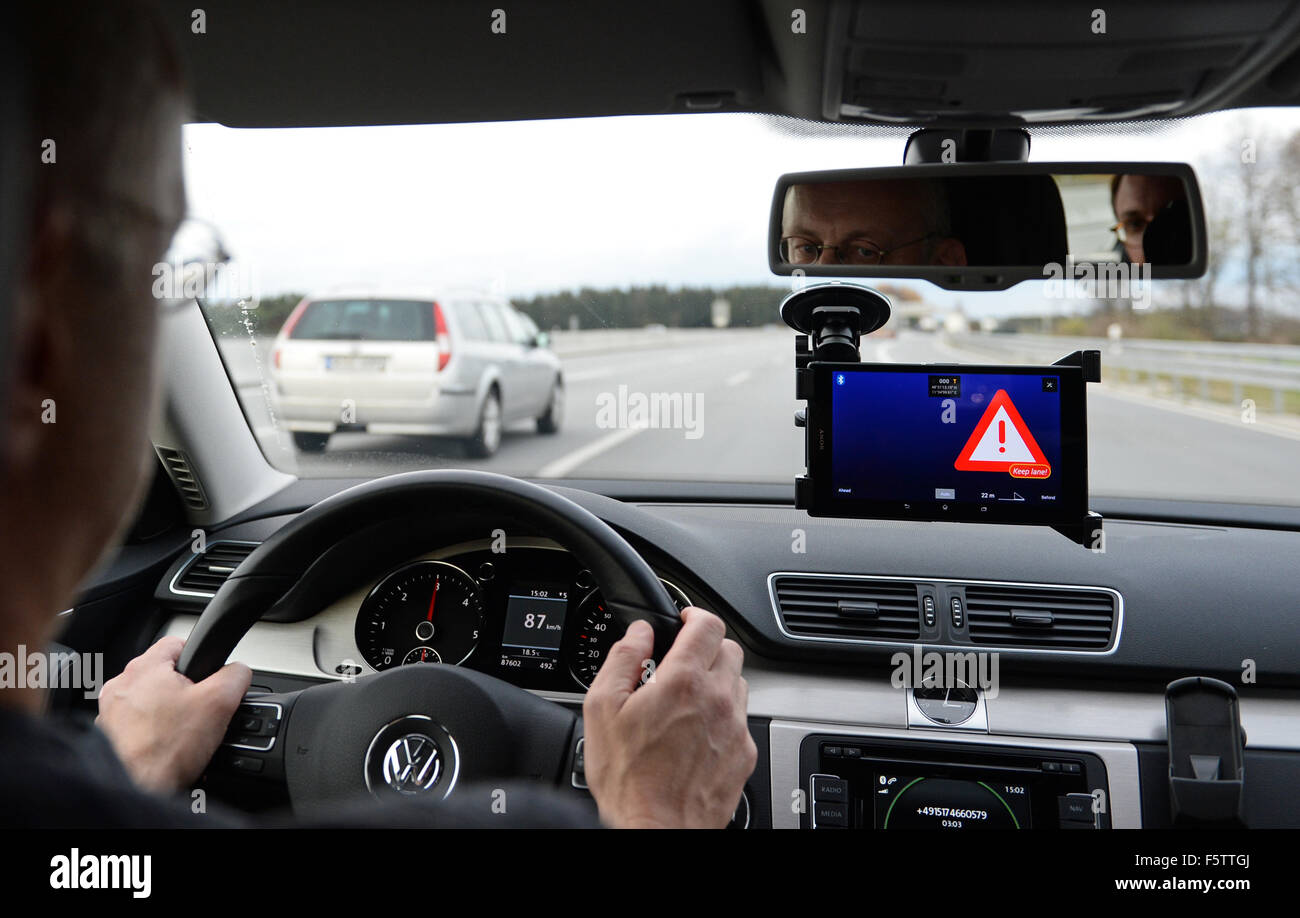 A test driver drives a car which is connected to another car via smart ...