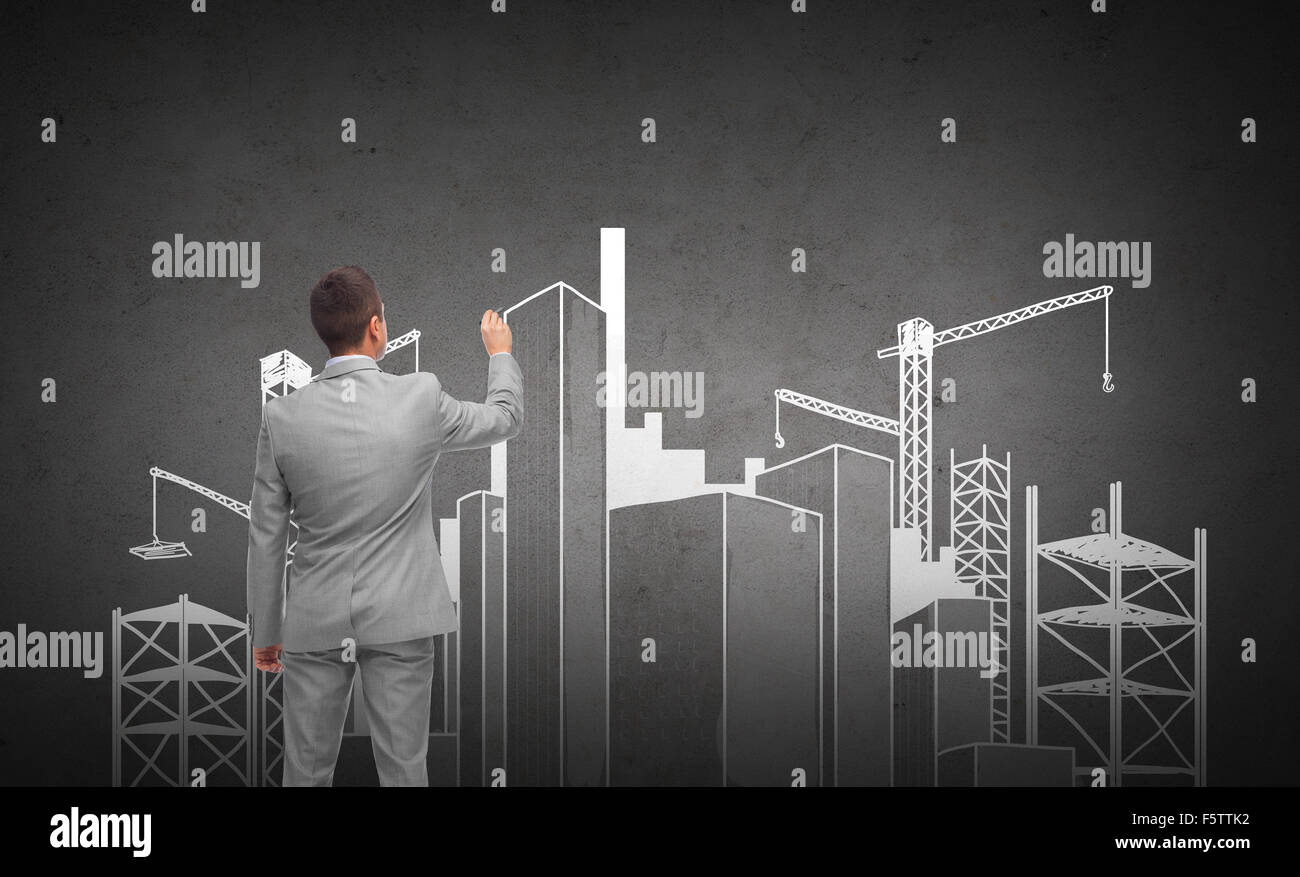 businessman drawing city construction site Stock Photo - Alamy