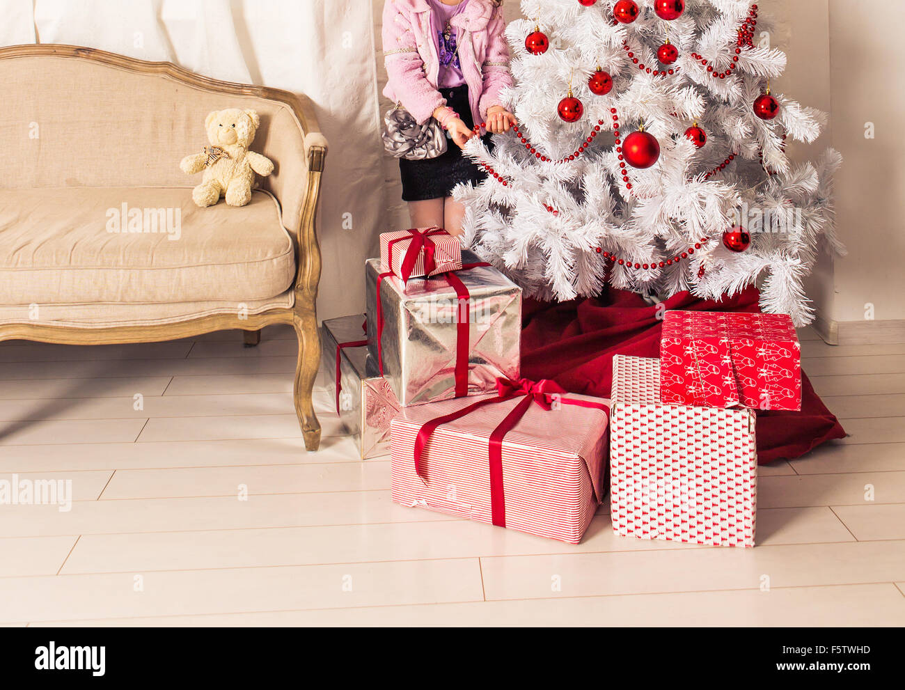 Little girl decorating christmas tree Stock Photo - Alamy