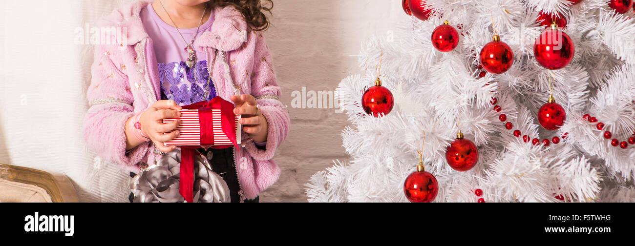 happy little child with gifts and Christmas tree Stock Photo - Alamy