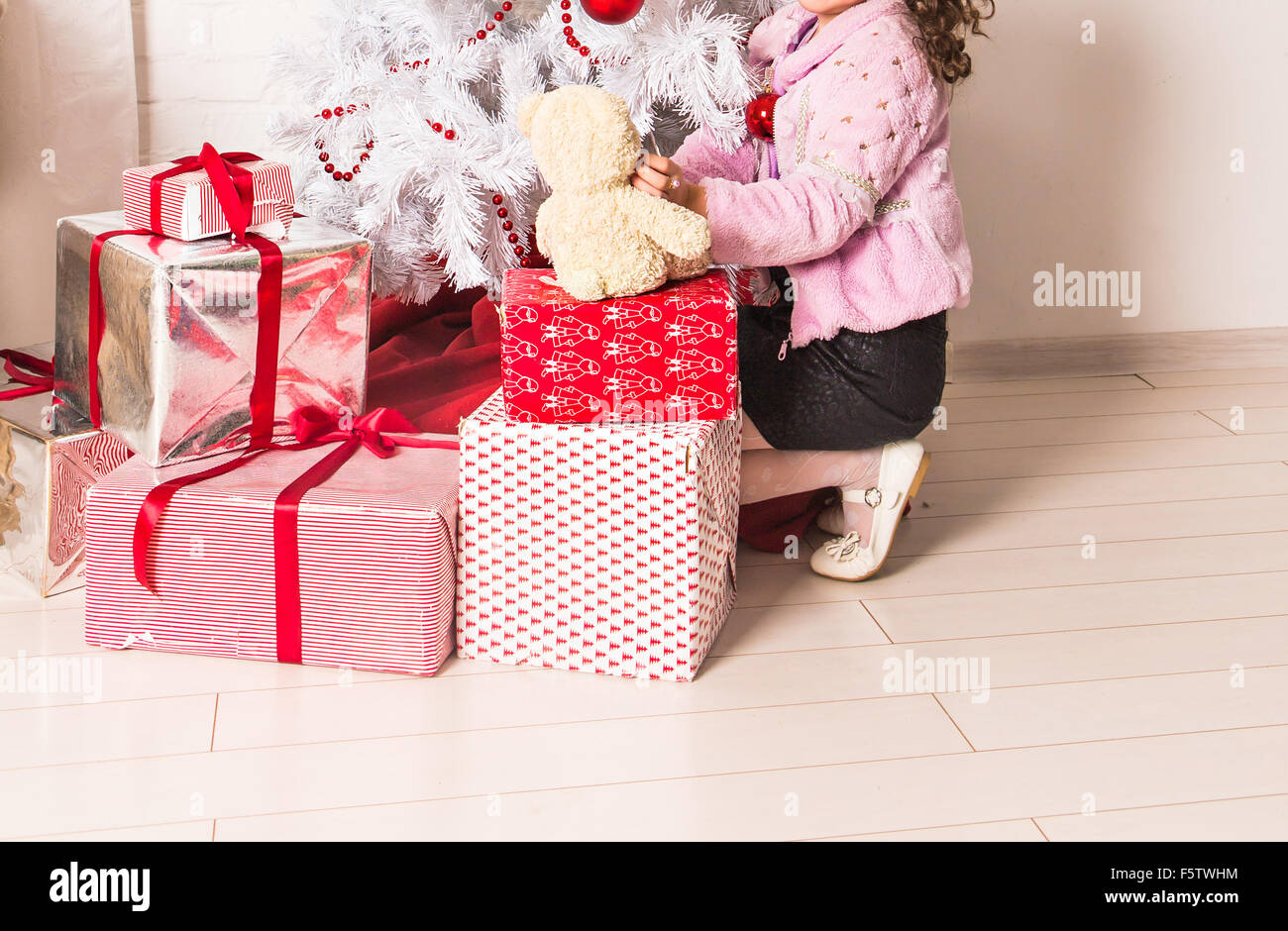 happy little child with gifts and Christmas tree Stock Photo - Alamy