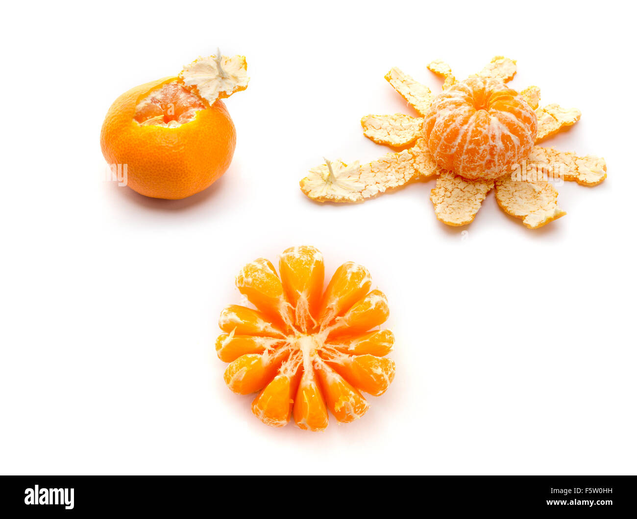 Two peeled tangerine and one unhulled isolated on white background ...