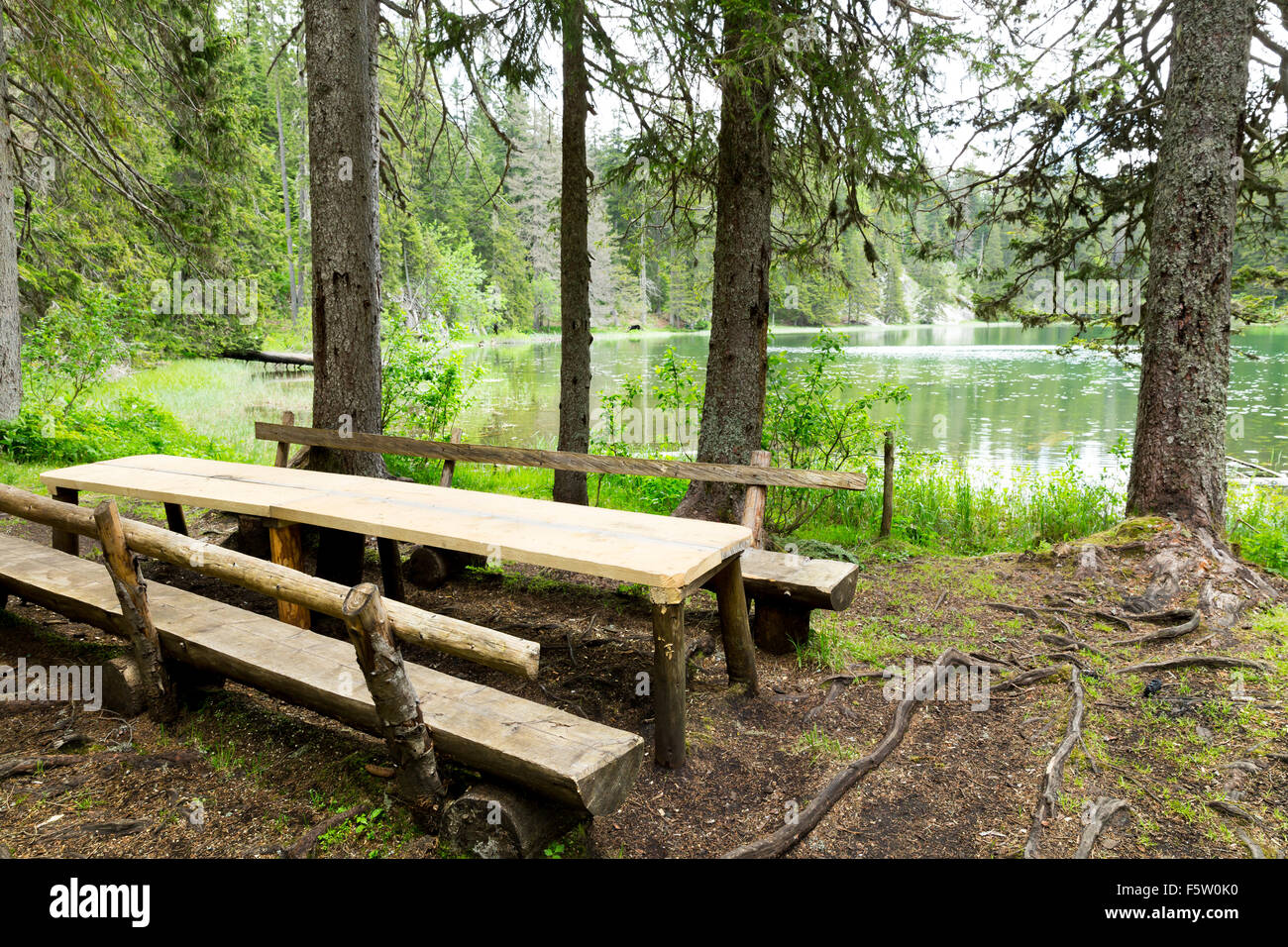 Lake and wooden benches and table Stock Photo - Alamy