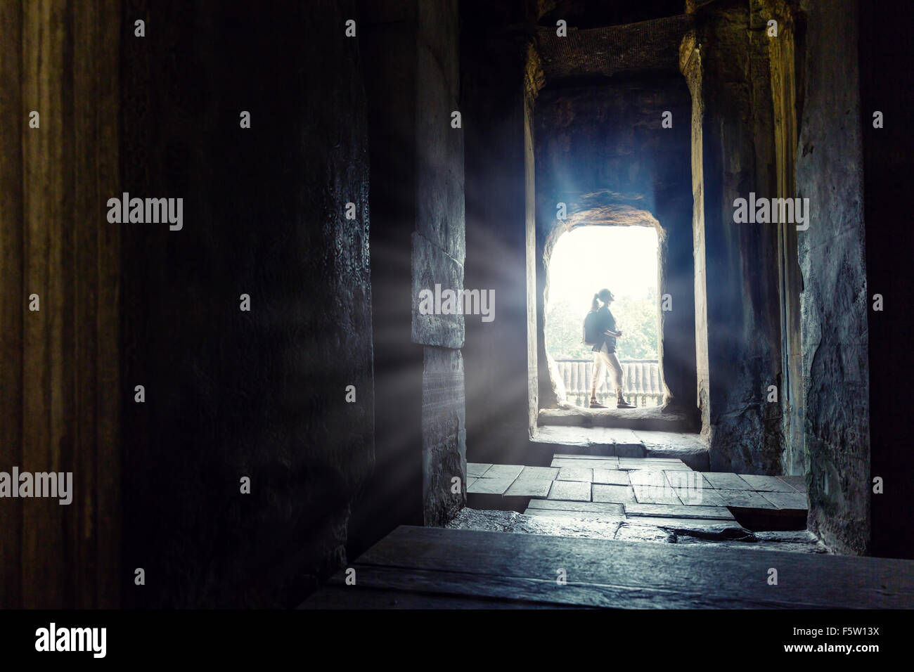 Gallery way at the ancient temple and fmale in the door Stock Photo - Alamy