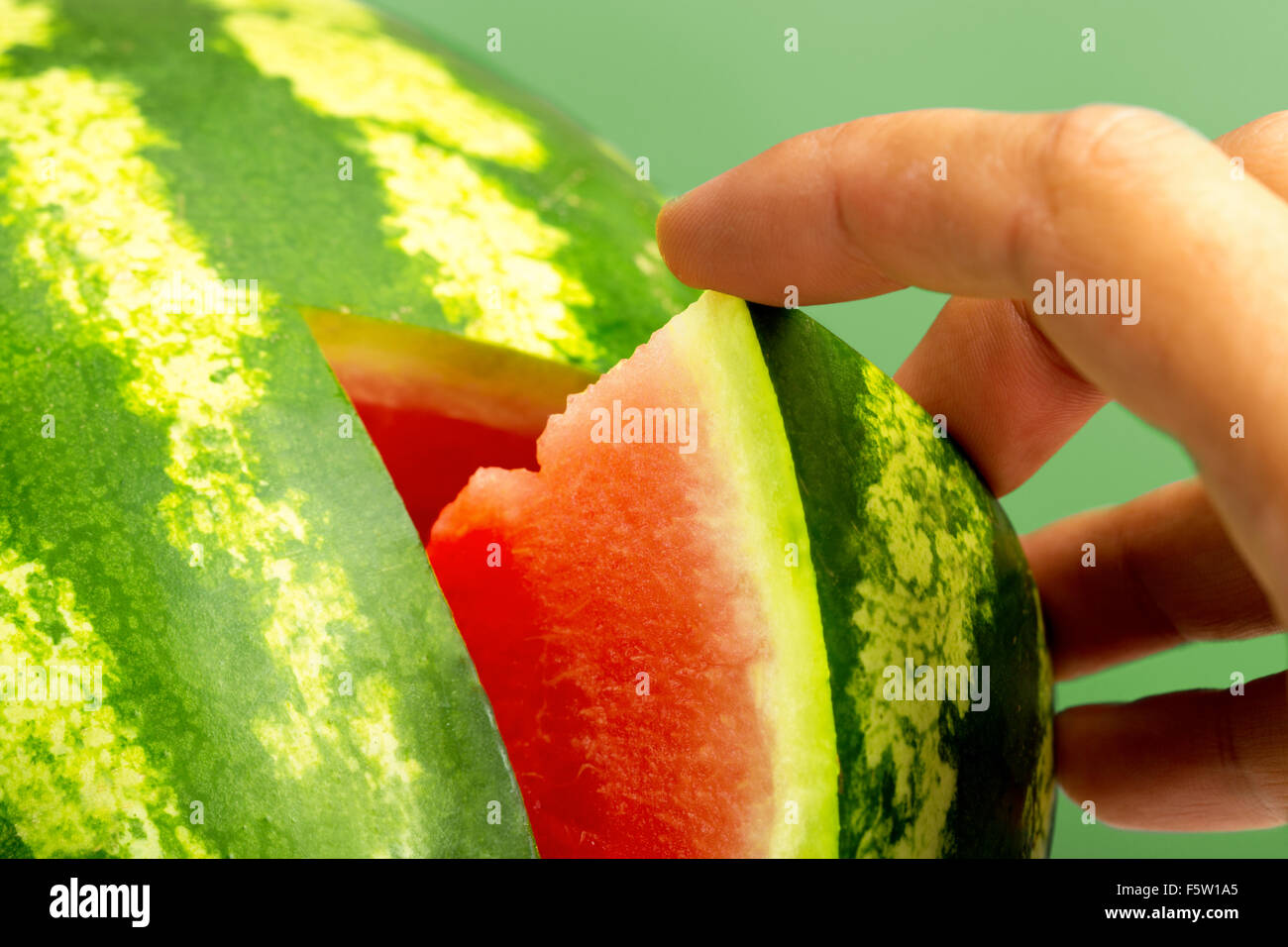Hand taking piece of fresh watermelon Stock Photo - Alamy