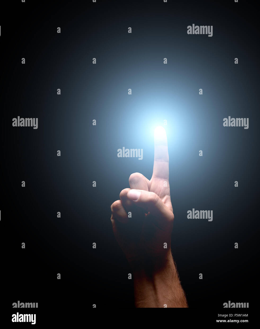 Concept picture with light from finger Stock Photo - Alamy