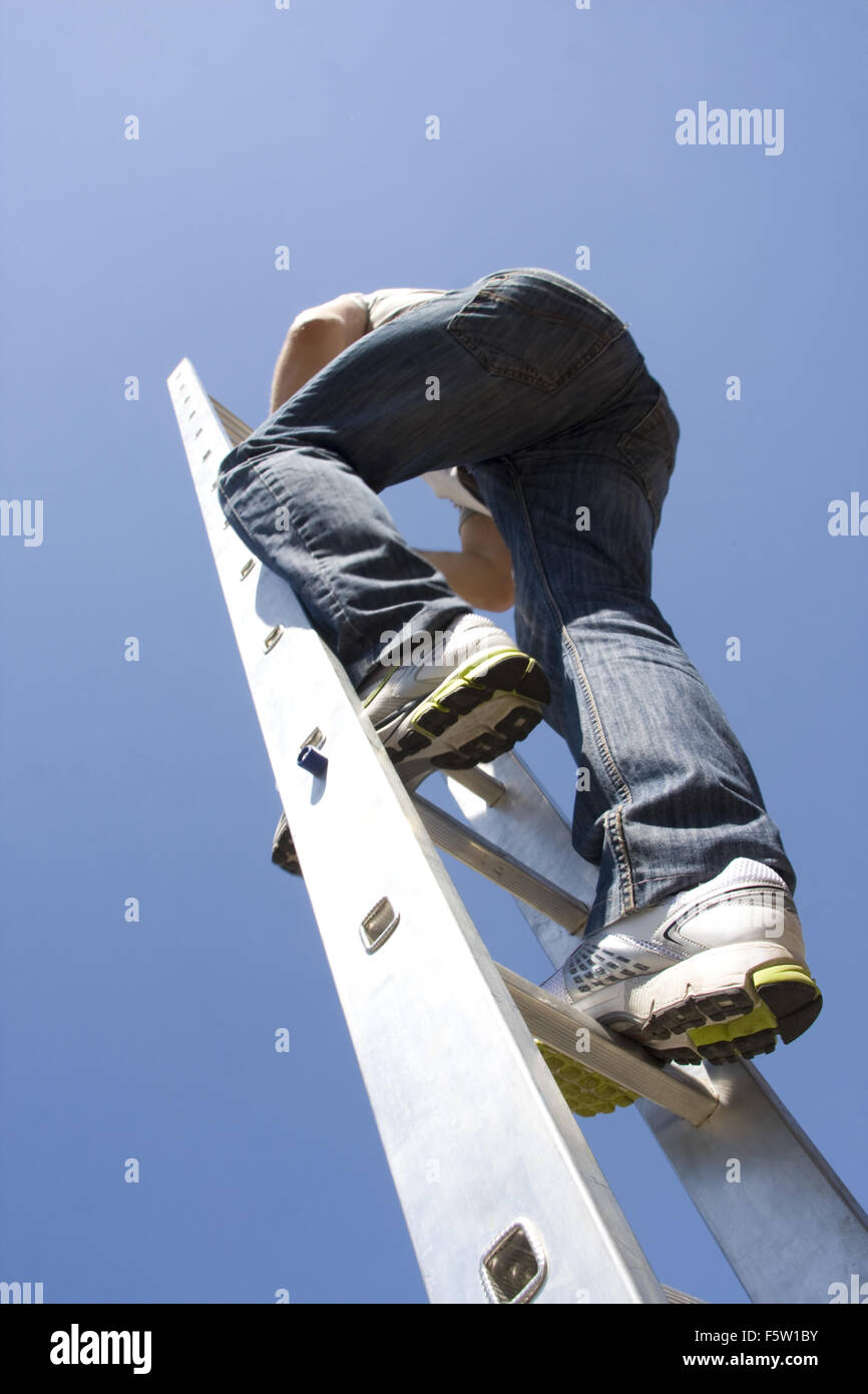 Man climbing ladder Stock Photo - Alamy