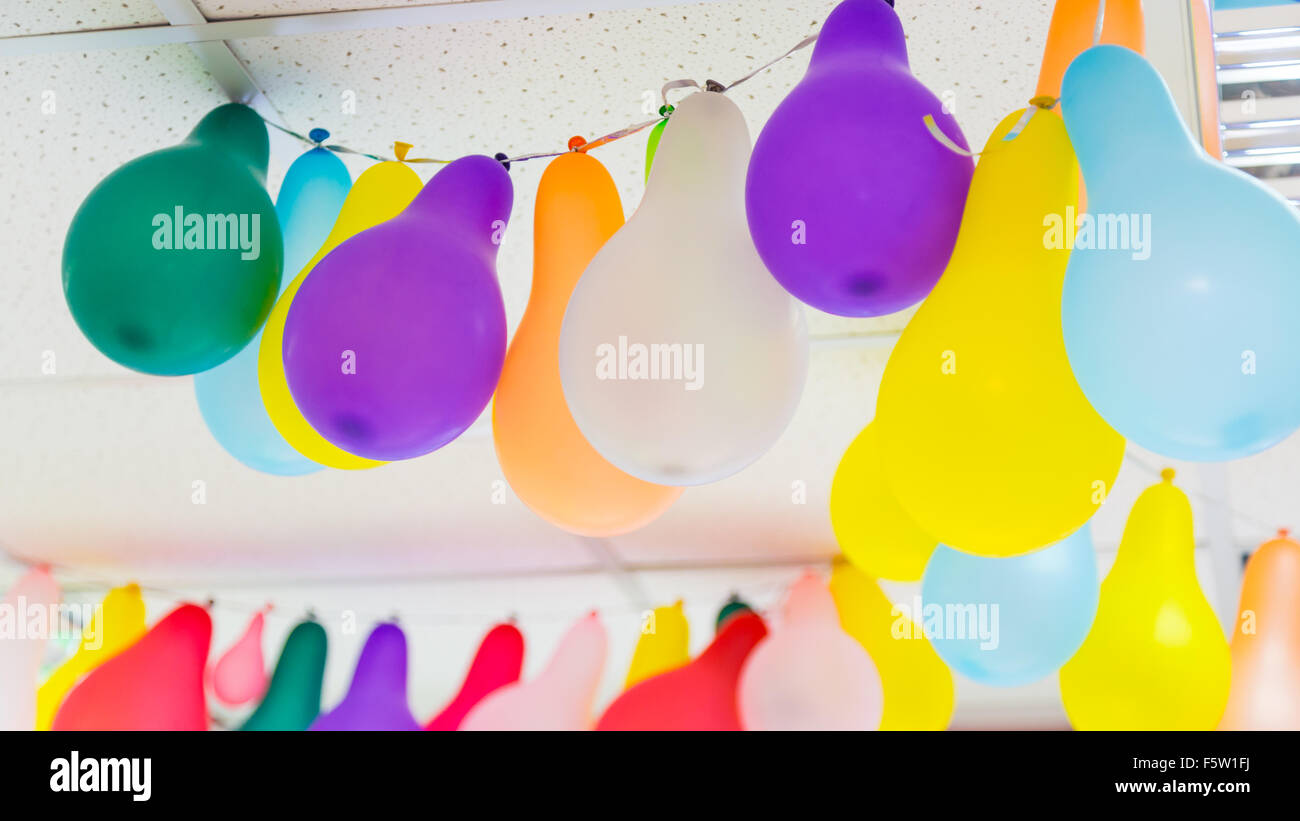 Colorful bunch of balloons hanging from ceiling Stock Photo - Alamy