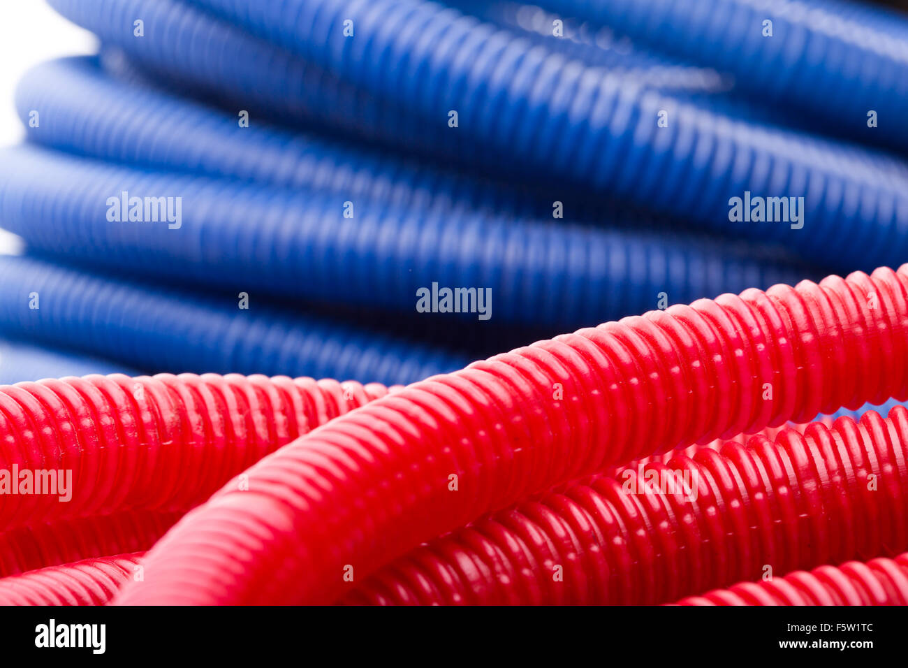 Closeup of long red and blue water pipes Stock Photo - Alamy