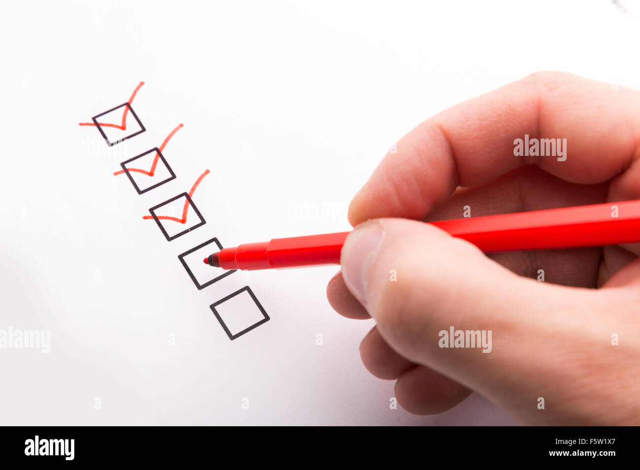 Hand with pen and check boxes on white Stock Photo - Alamy