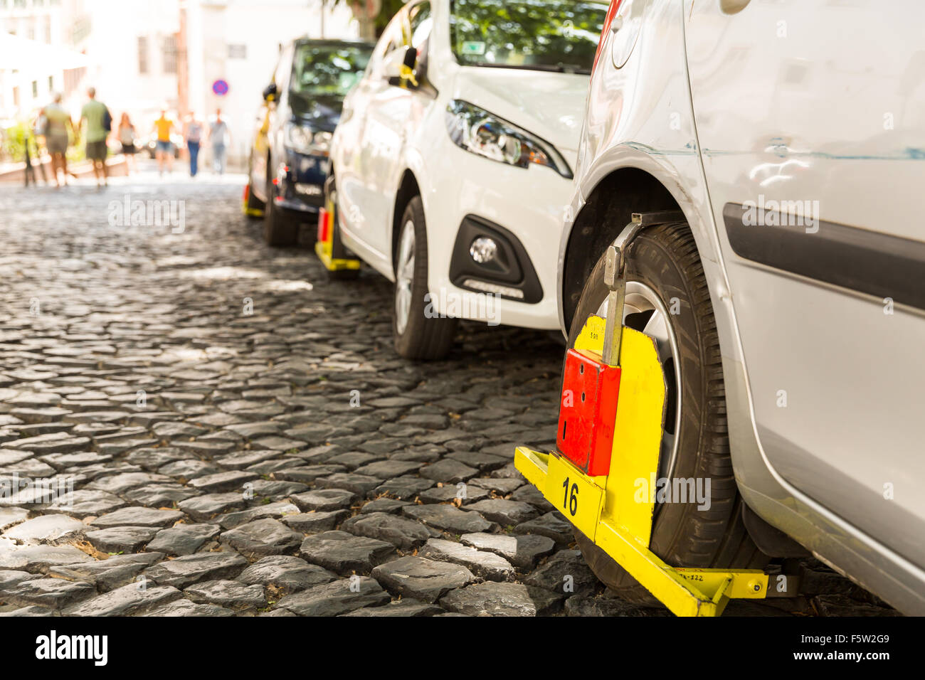 Blocked car wheel for parking violation Stock Photo - Alamy