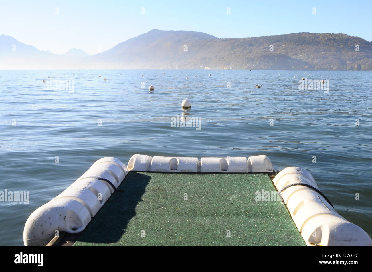Landscape of Annecy lake and boat pontoon during fall time in France ...