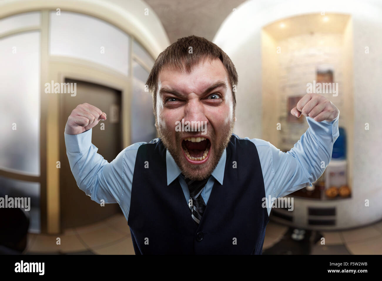 Businessman screaming at the office Stock Photo - Alamy