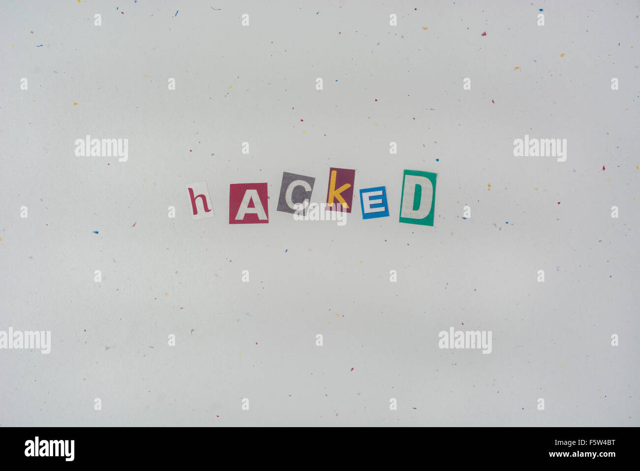 Cut-out letters making up a ransomware message notification on a rough ...