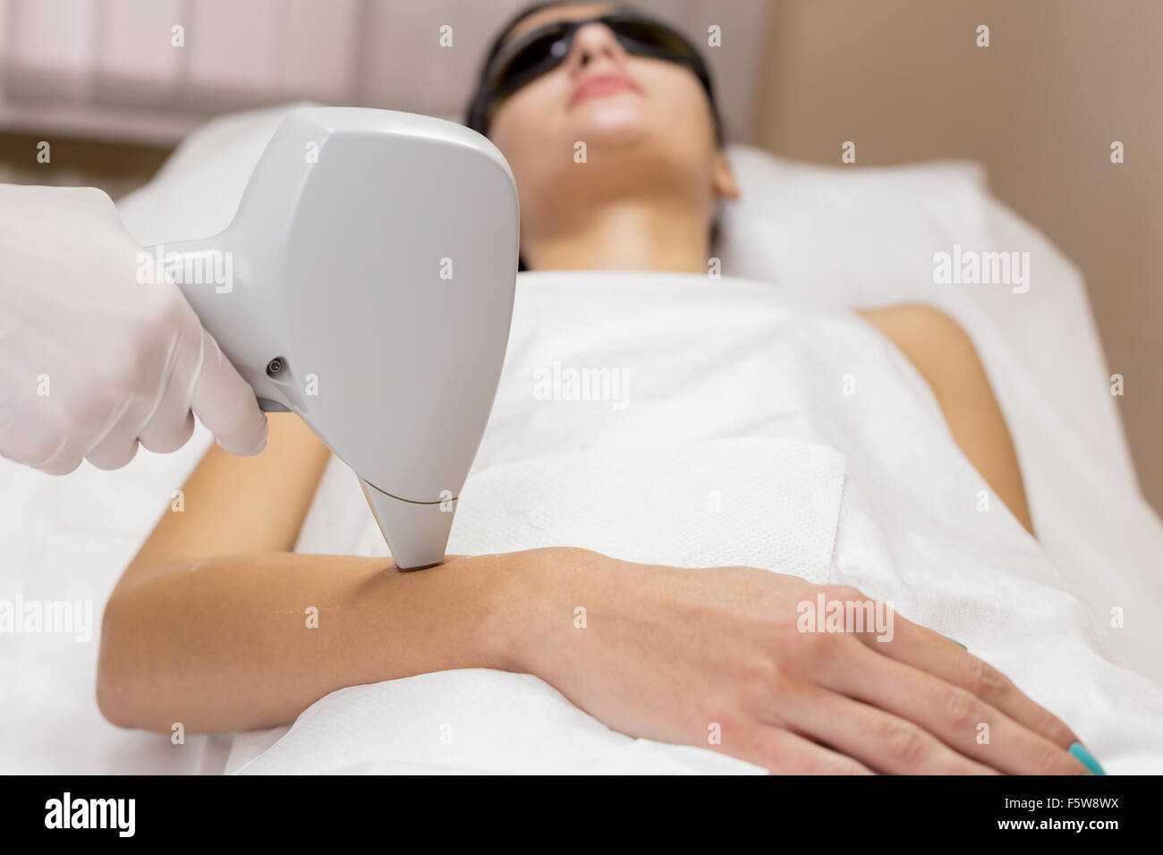 Laser hair removal on client hand in beauty salon Stock Photo - Alamy
