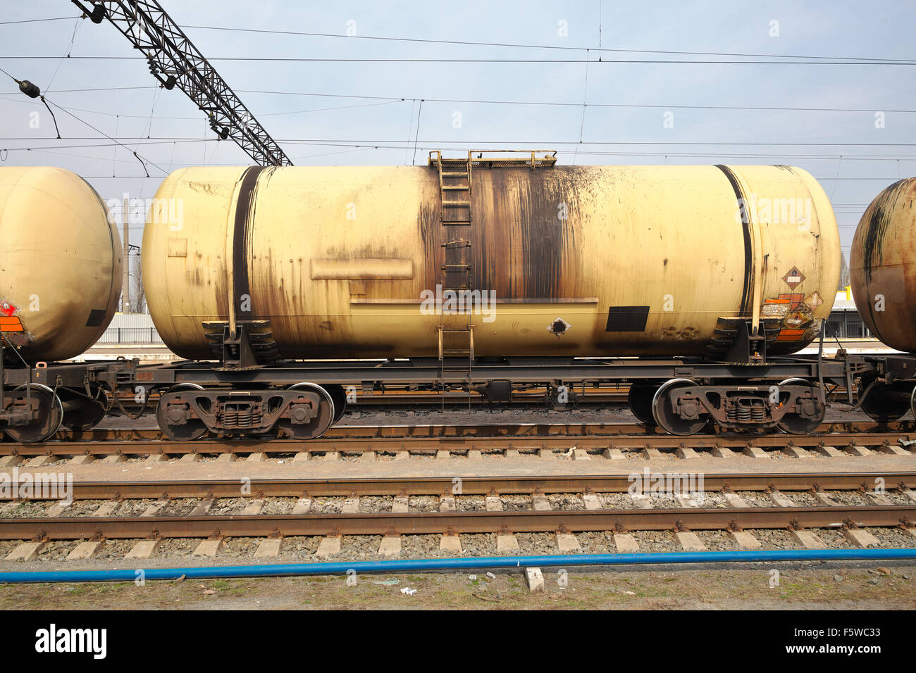 Cargo train with oil cars on the railway station Stock Photo - Alamy