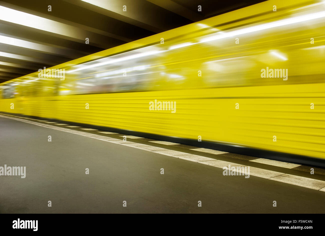 Yellow U-Bahn subway train arriving at a station in Berlin, Germany ...