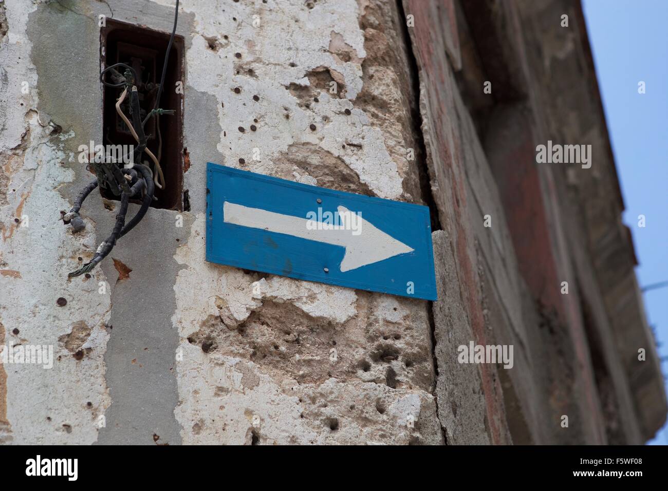 Arrow sign on an imperfect wall in the Old Town Center of Havana, Cuba ...