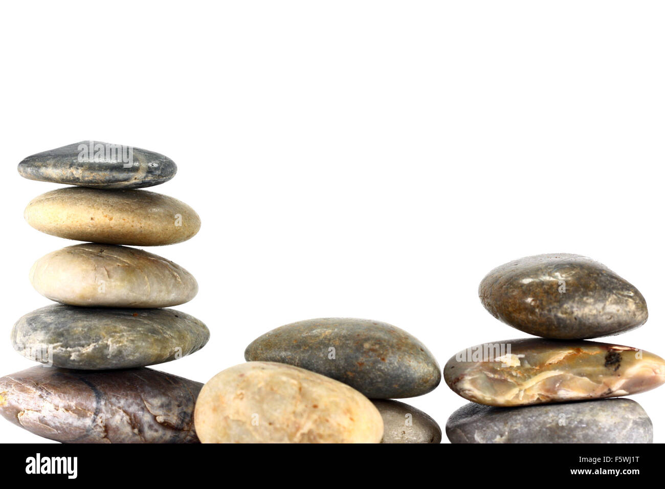 Rocks balancing on white background Stock Photo - Alamy