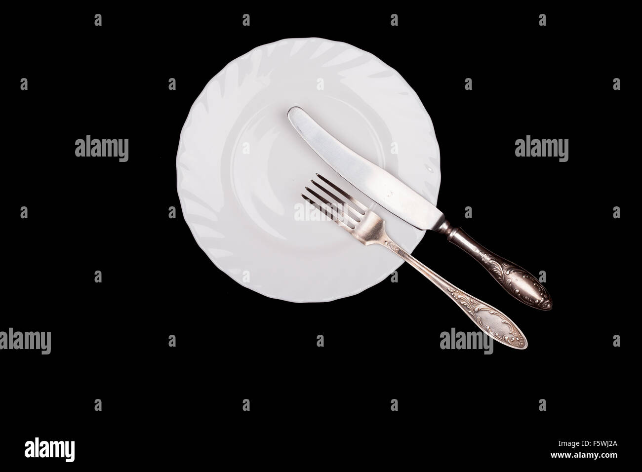 Etiquette sign. Plate, fork, knife top view isolated on black Stock ...