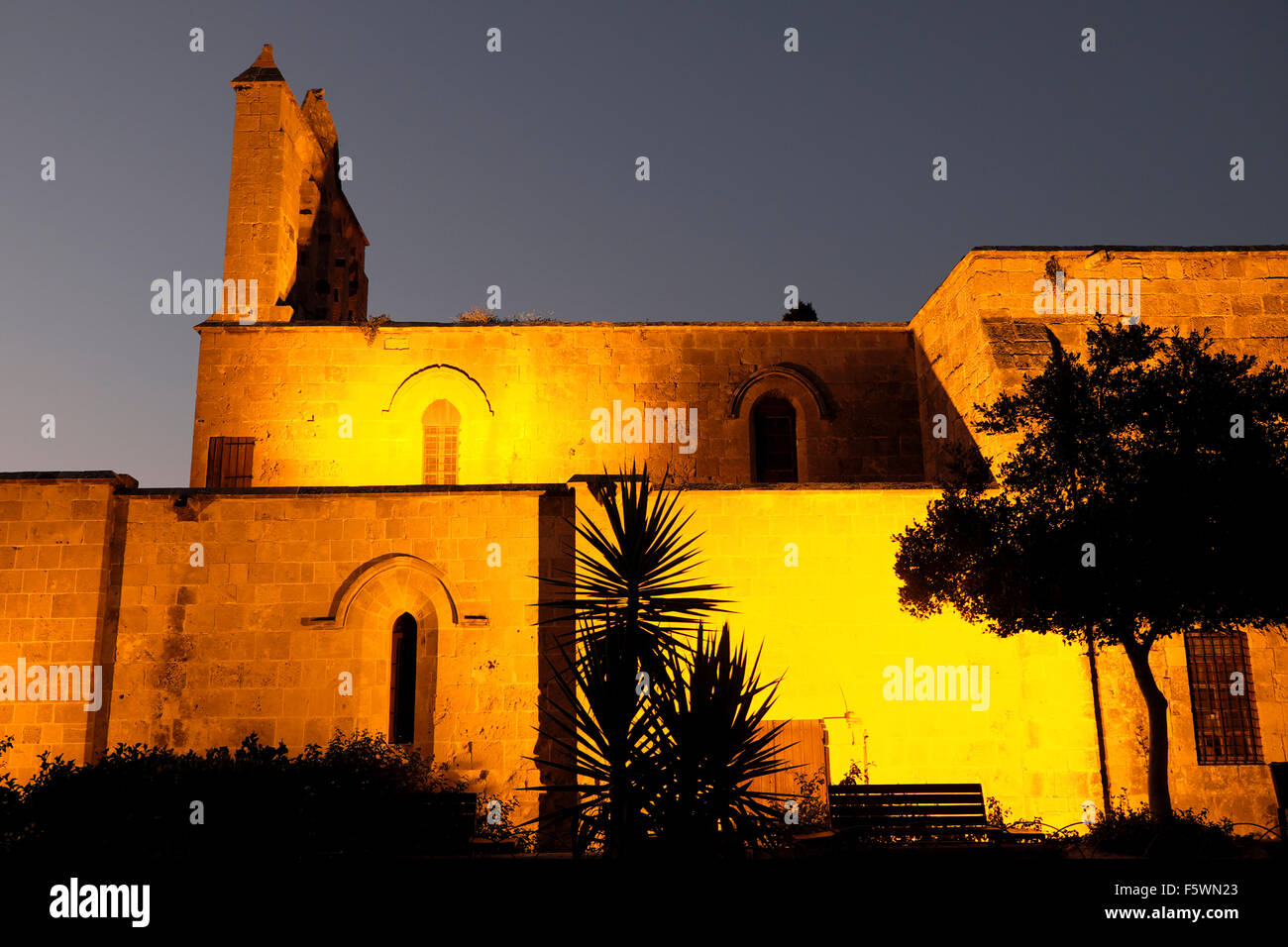 Side view of Bellapais Monastery floodlit at night in Bellapais Village ...