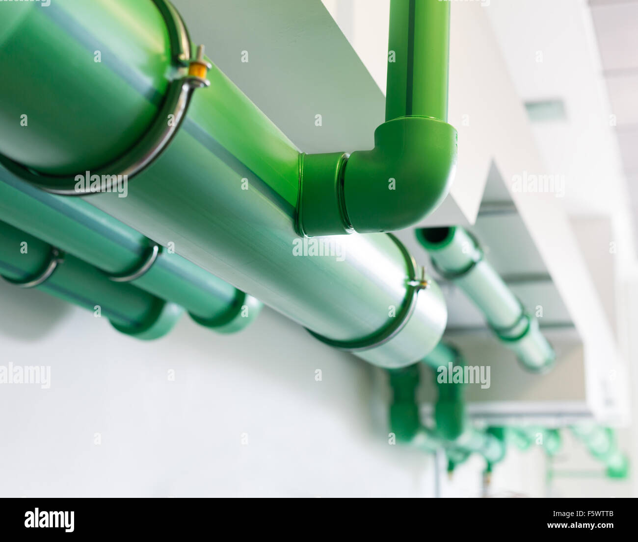 Green pipelines - water supply system Stock Photo - Alamy