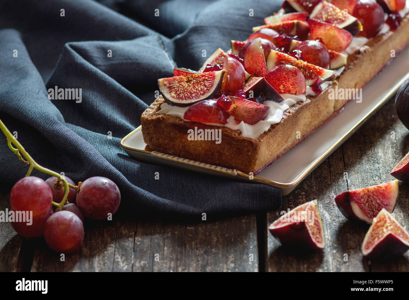 Homemade rectangular Tart with red Grapes, Figs and Whipped cream in ...