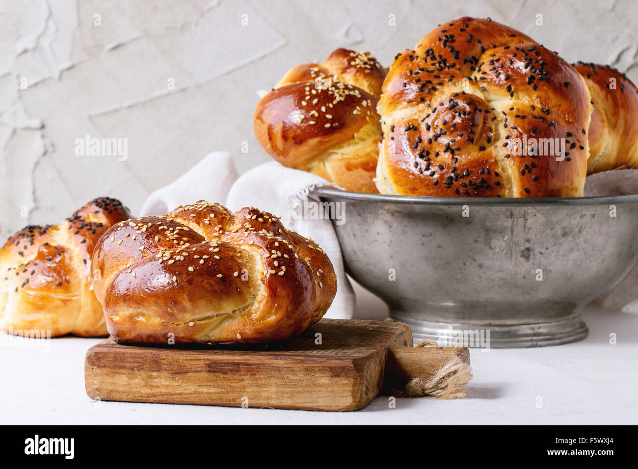 Heap of sweet round sabbath challah bread with white and black sesame ...