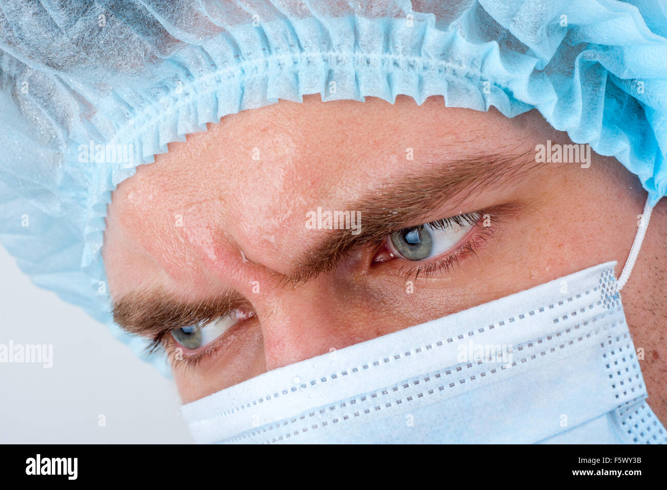 Doctor portrait sweat hi-res stock photography and images - Alamy