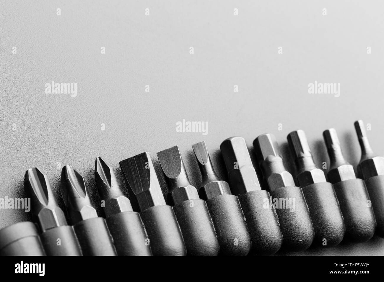 Macro of screwdriver bits on grey Stock Photo - Alamy
