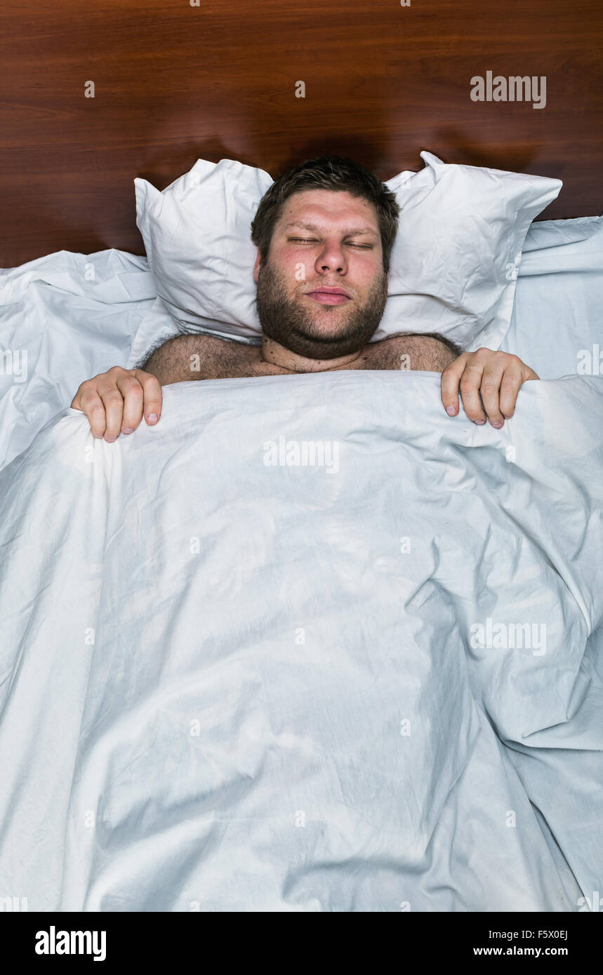 Top view of man sleeping in white bed Stock Photo - Alamy