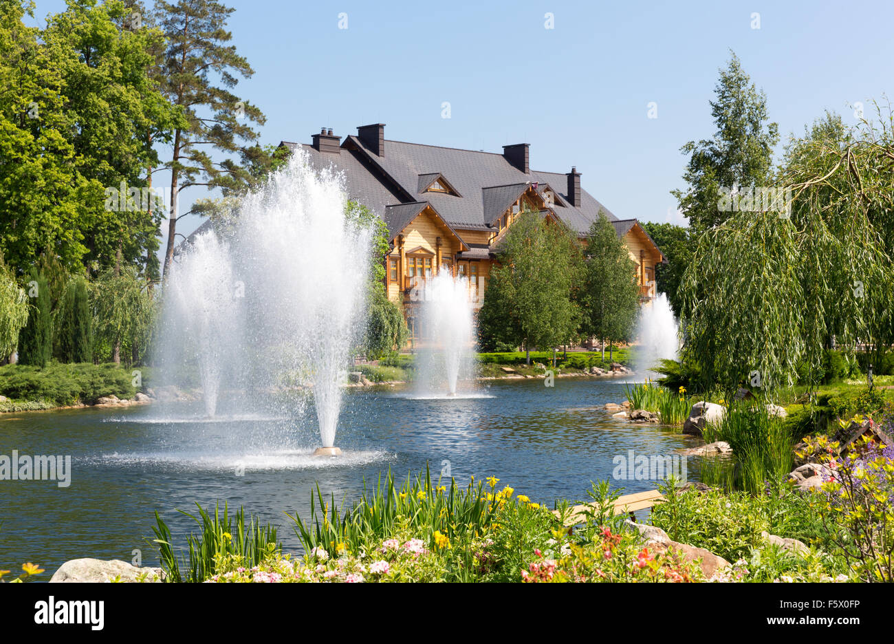 Beautiful lake in spring park with fountains Stock Photo - Alamy