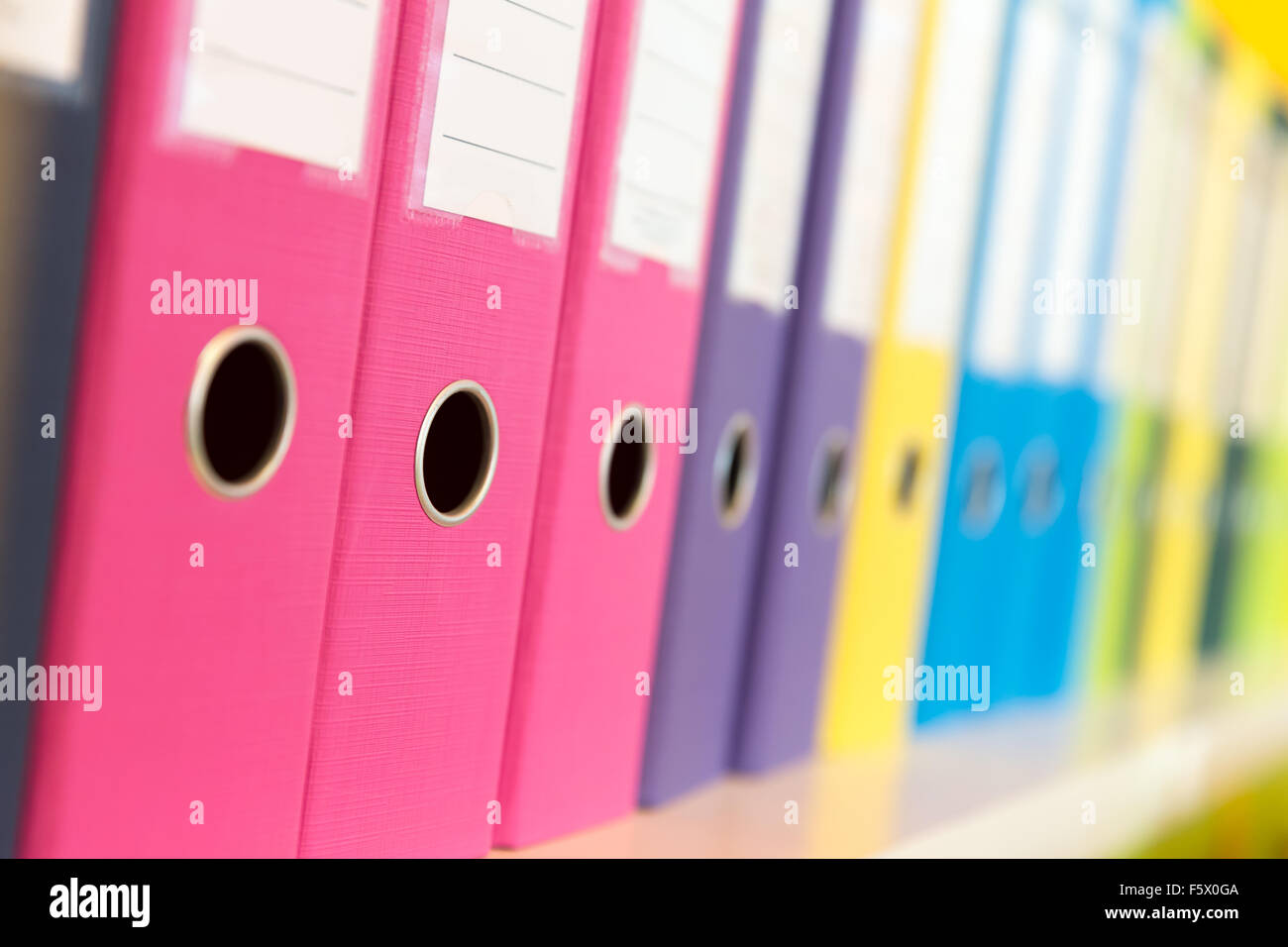 Number of folders standing on the shelf in the office Stock Photo - Alamy
